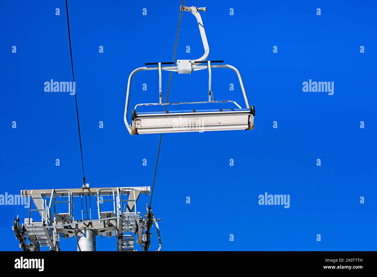 close-up of ski lifts against the background of a blue sky with clouds ...