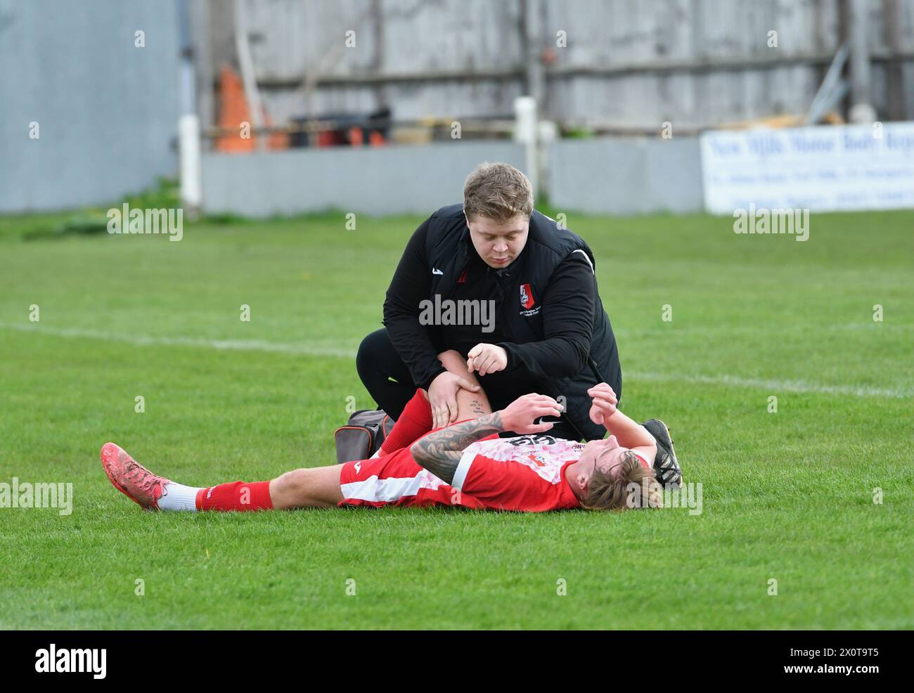 A physiotherapist attends an injured player in the semi-professional ...
