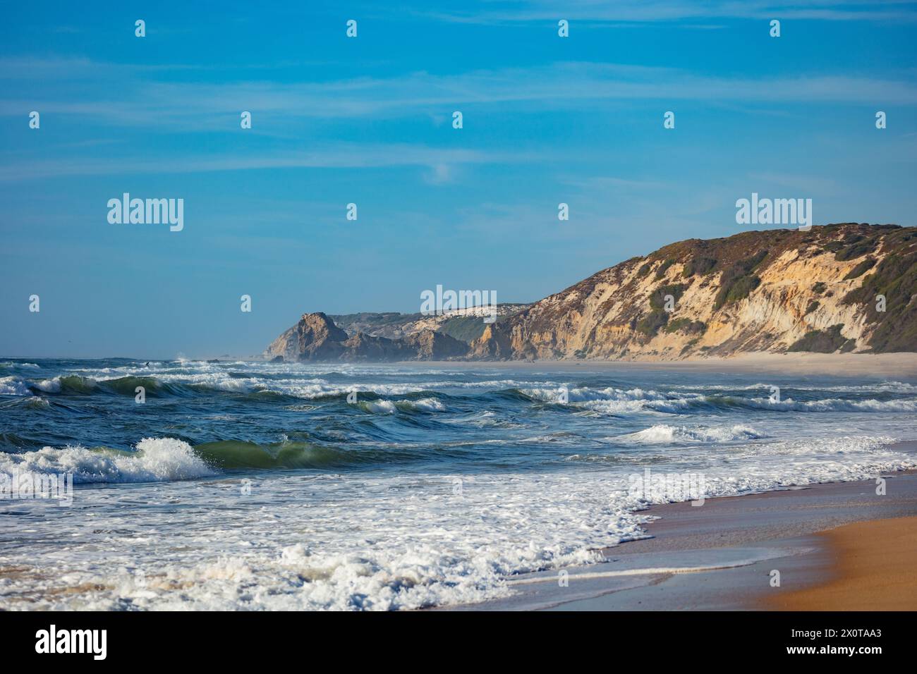 Coastal scenery with gentle surfs meeting shore steep cliffs Stock ...