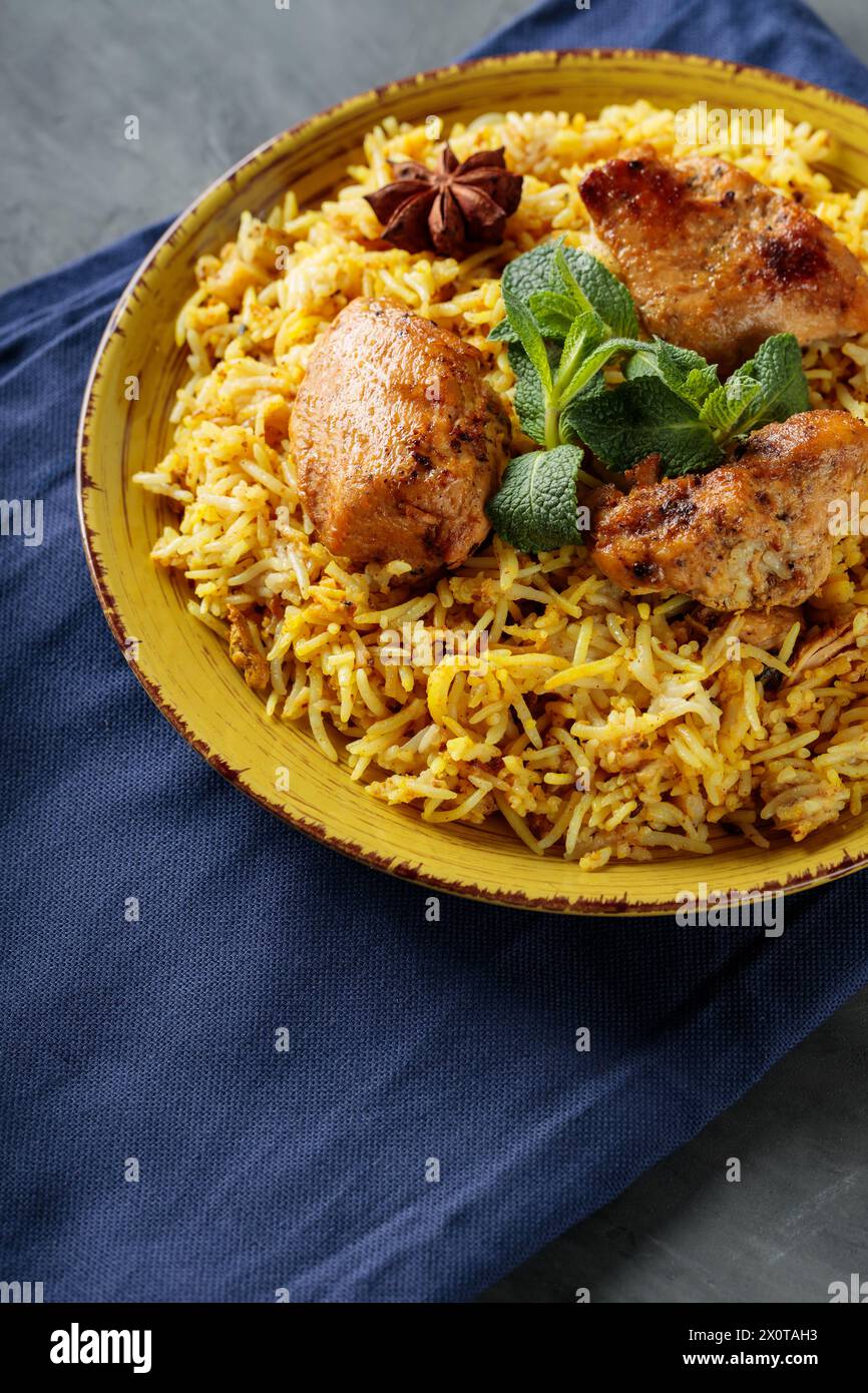 Indian Chicken Biryani with Spices on Yellow Plate, Trendy Indian and ...