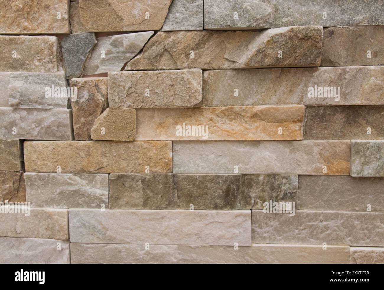 Beautiful beige structural stone wall of the ancient building consists ...