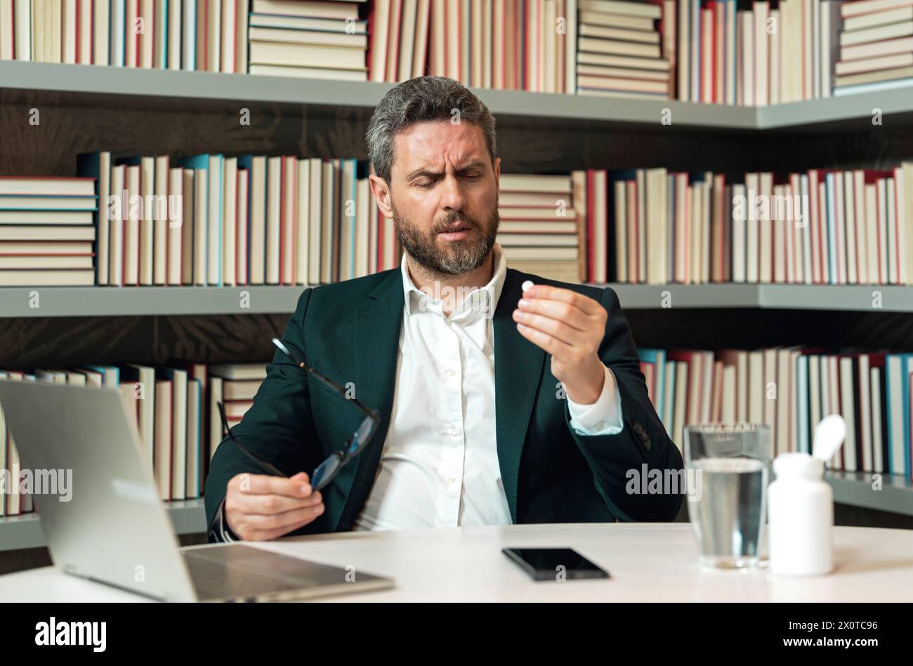 Headache and eye strain on laptop. Business man with stress and fatigue ...