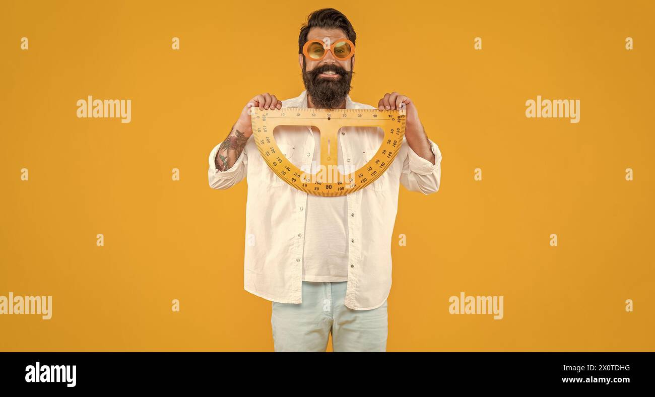 glad man hold geometry protractor on background. photo of man hold ...