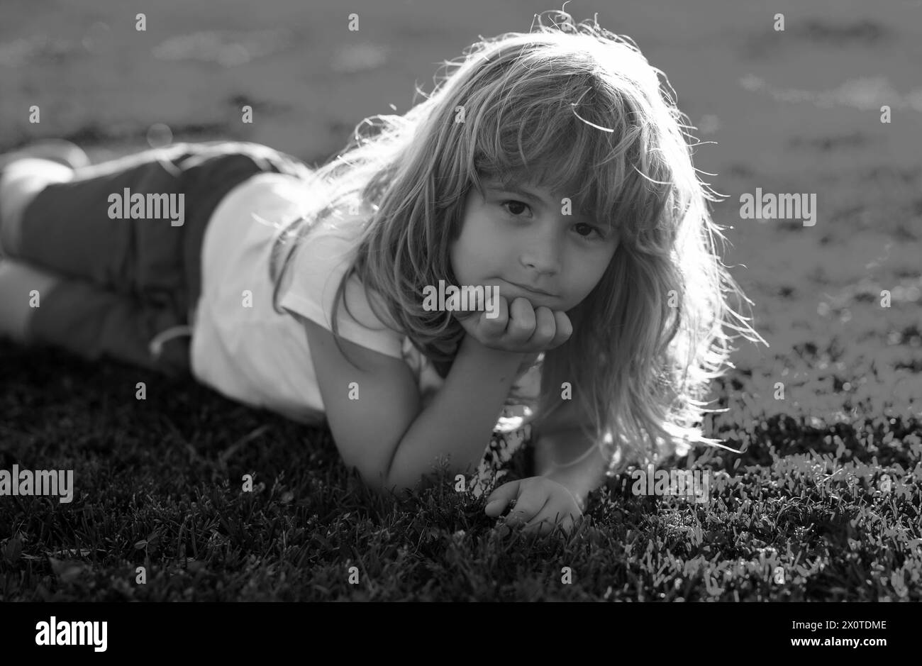 Spring child face. Smiling child boy with grass background. Happy child ...