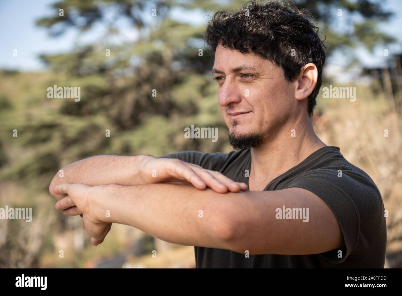 A man practicing martial arts, his posture reflecting determination and ...