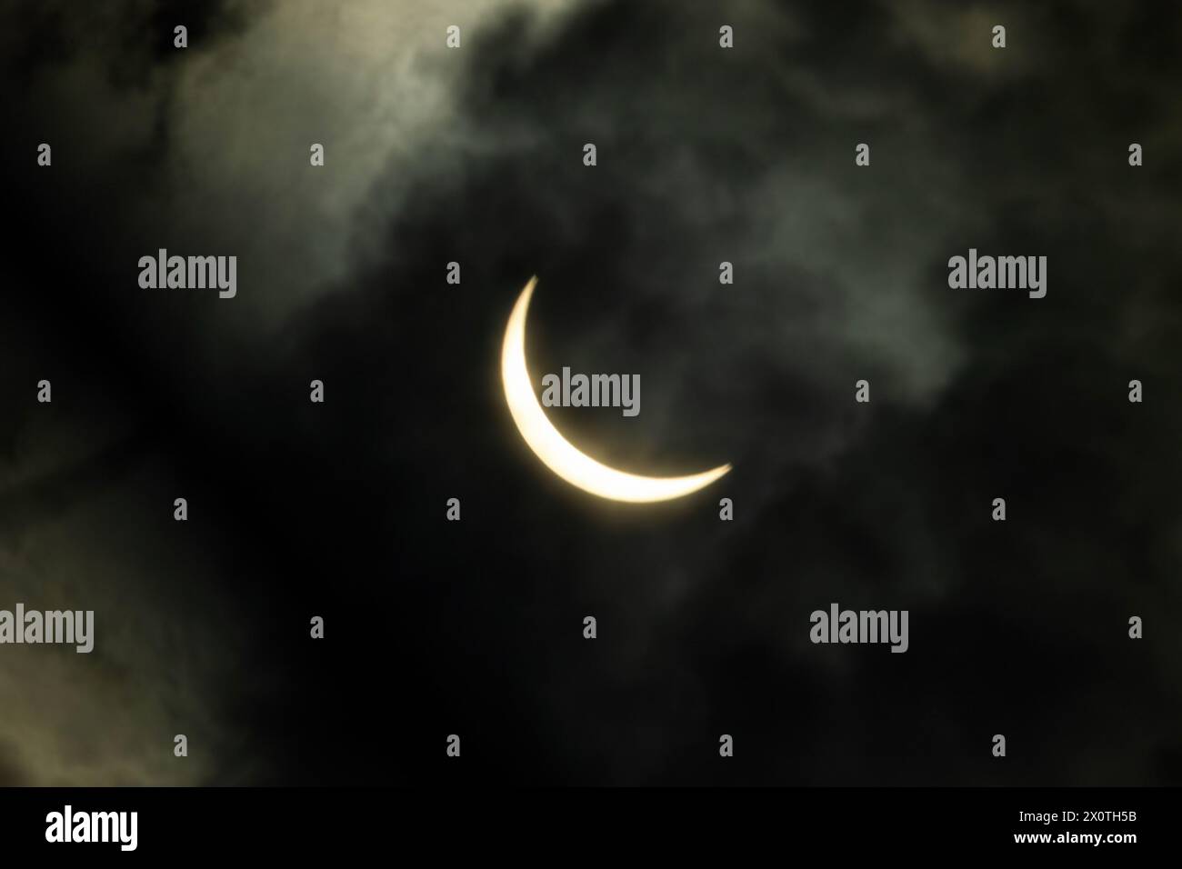 Partial solar eclipse high contrast close up with clouds Stock Photo ...