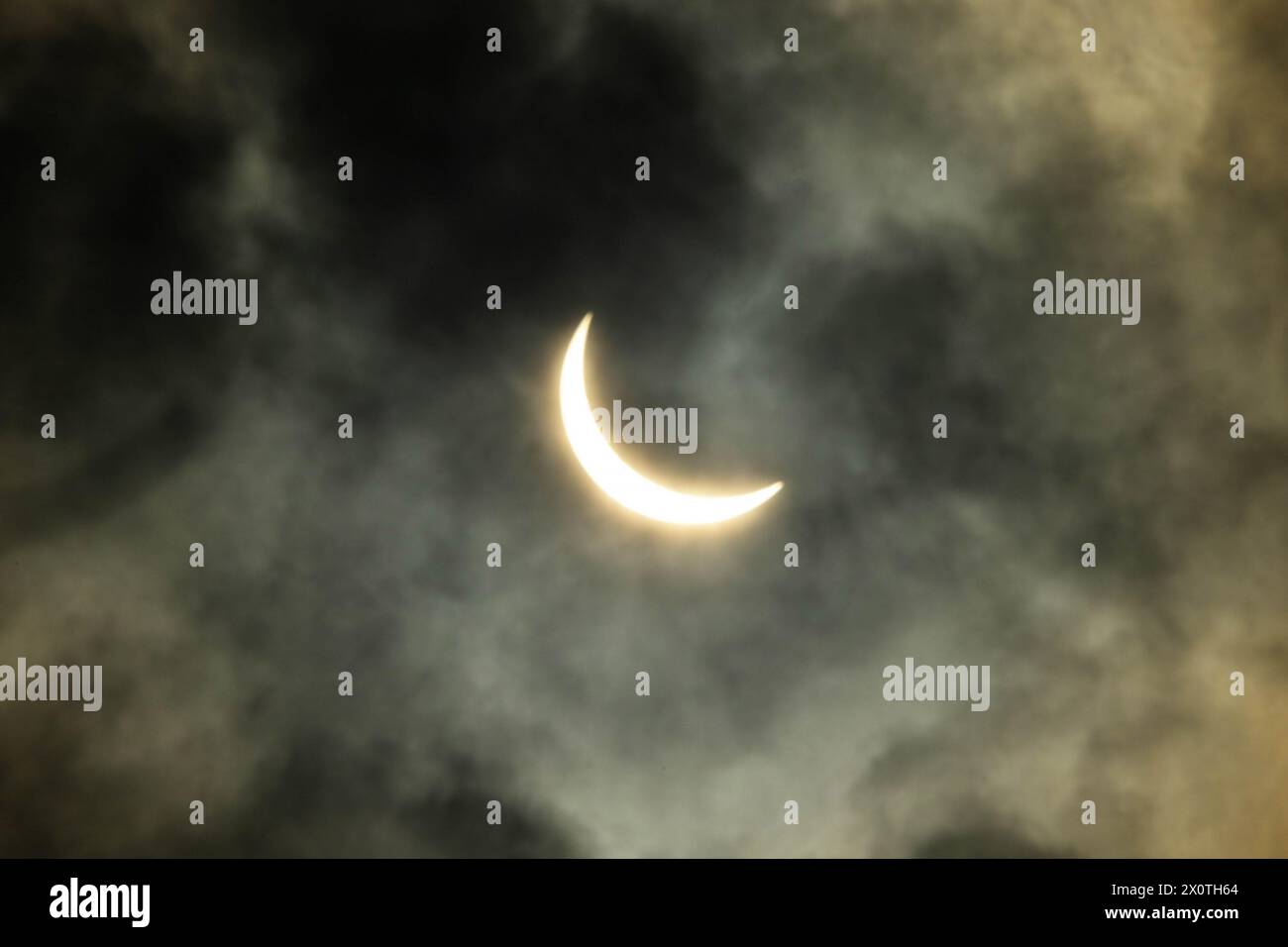 Partial solar eclipse high contrast close up with clouds Stock Photo ...