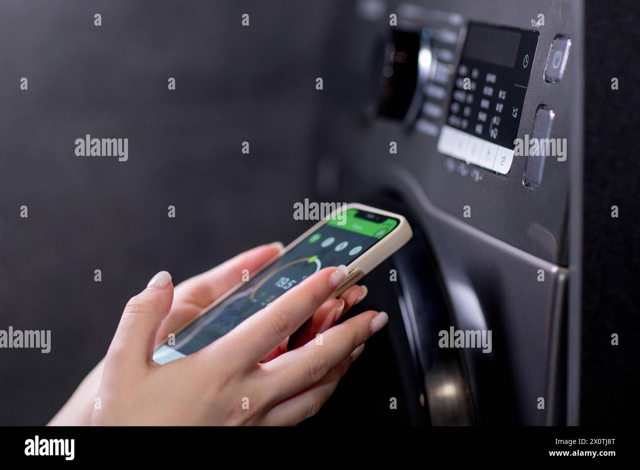 Smartphone with app used to control washing machines Stock Photo - Alamy