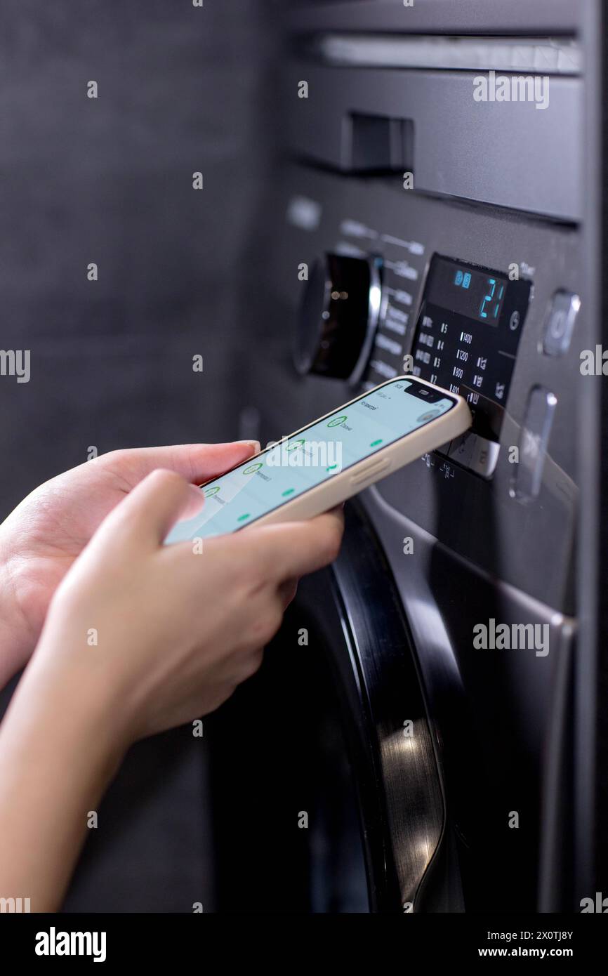 Smartphone with app used to control washing machines Stock Photo - Alamy