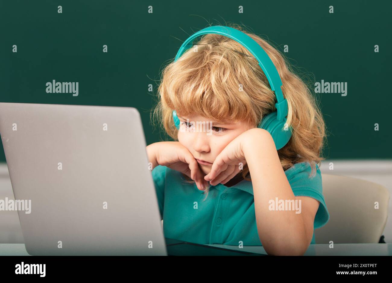 Serious boy student learning online in class. Kid study online video ...