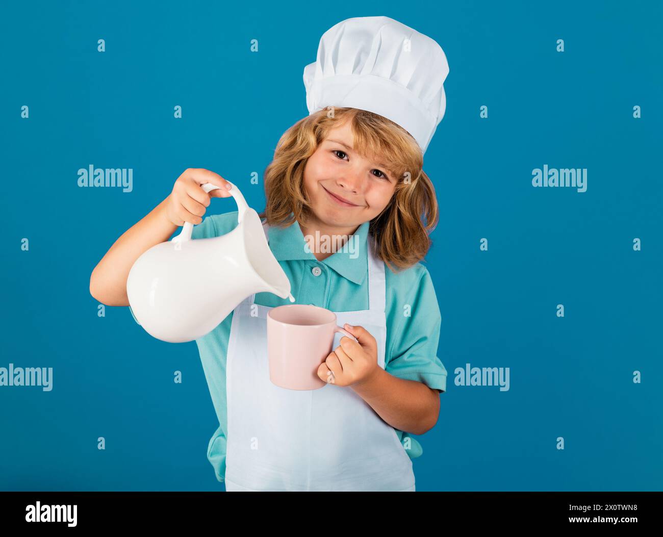Milk for children. Child chef cook prepares food in isolated blue ...