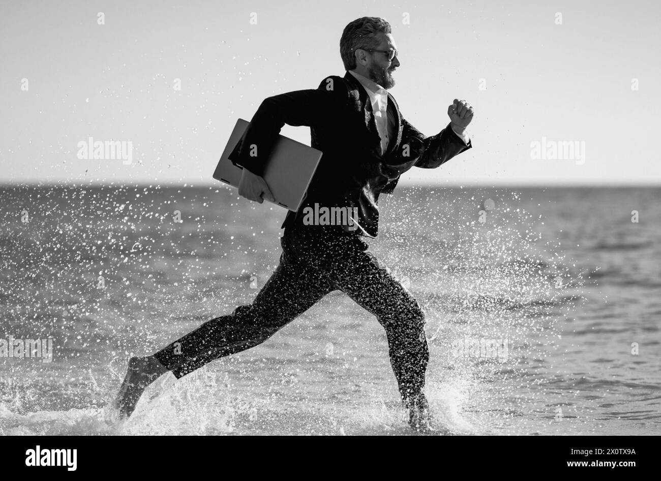Man in suit running into distance Black and White Stock Photos & Images ...