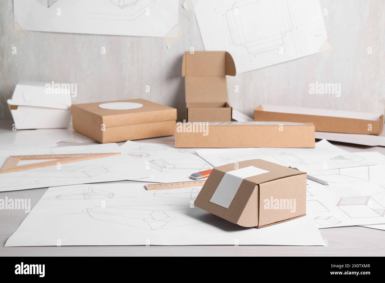 Creating packaging design. Drawings, boxes and stationery on light ...