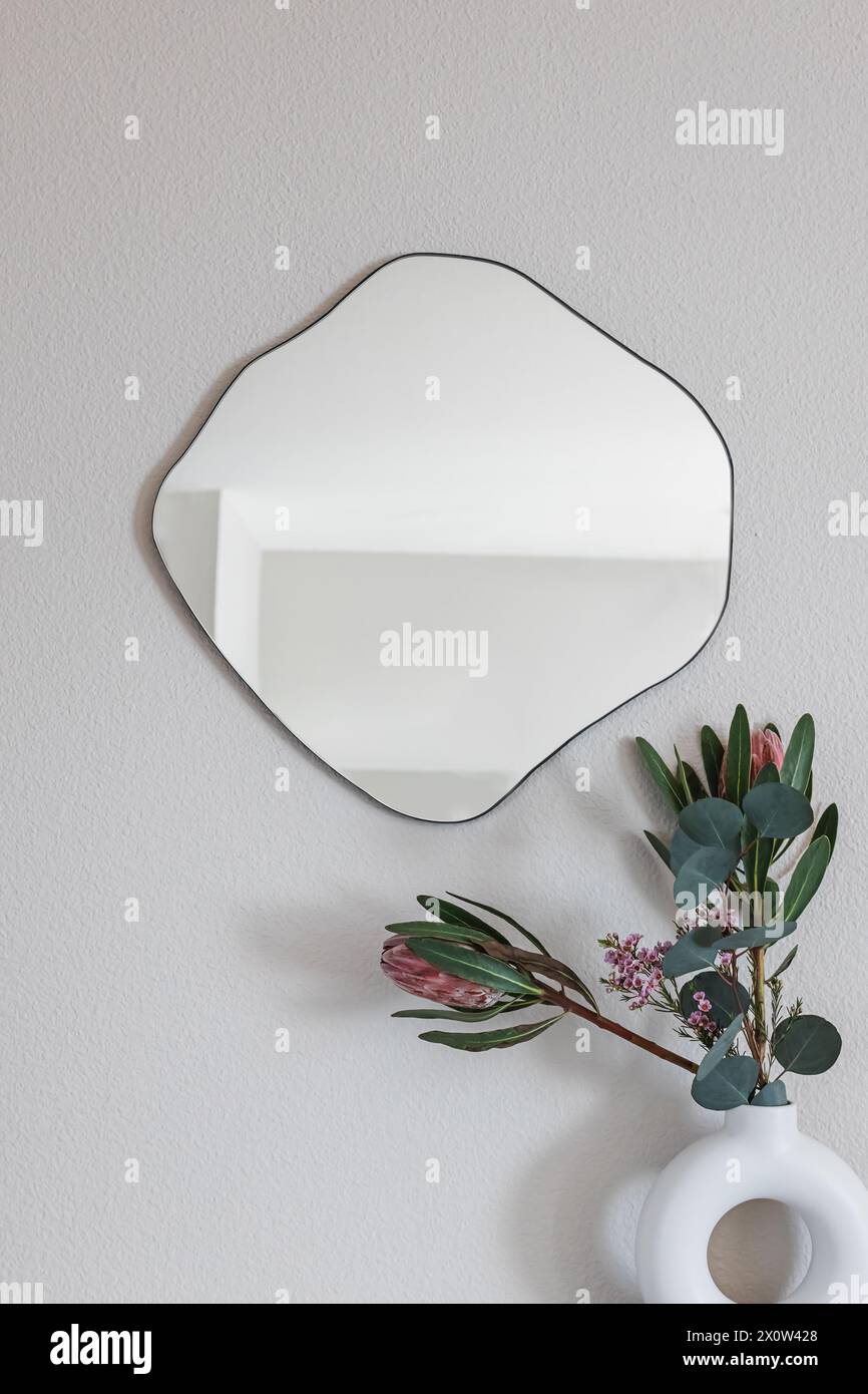 Elegant modern interior details, fluid shape mirror and decorative ...