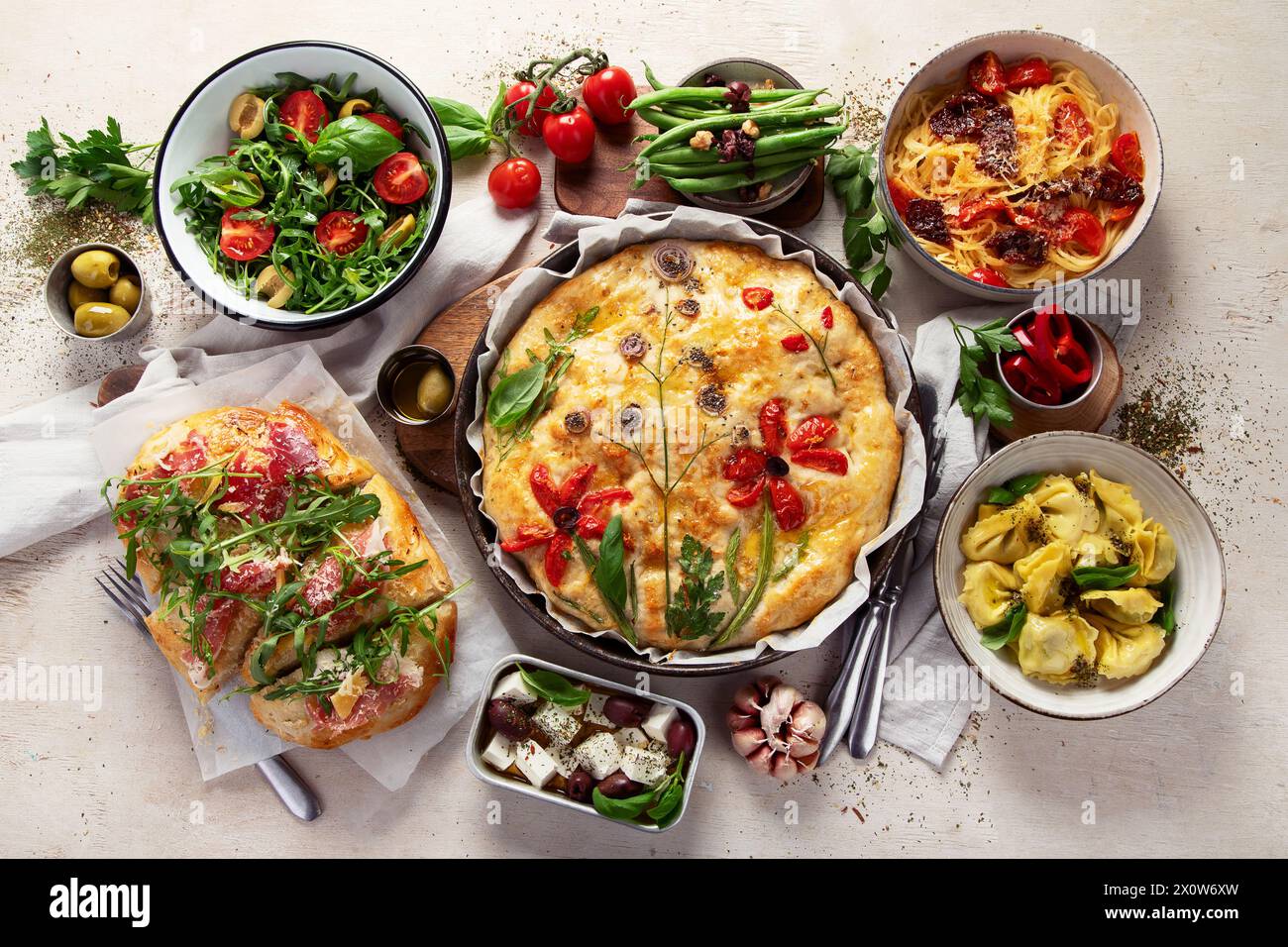 Table of italian meals dishes. Pizza, pasta, ravioli, focaccia on white ...