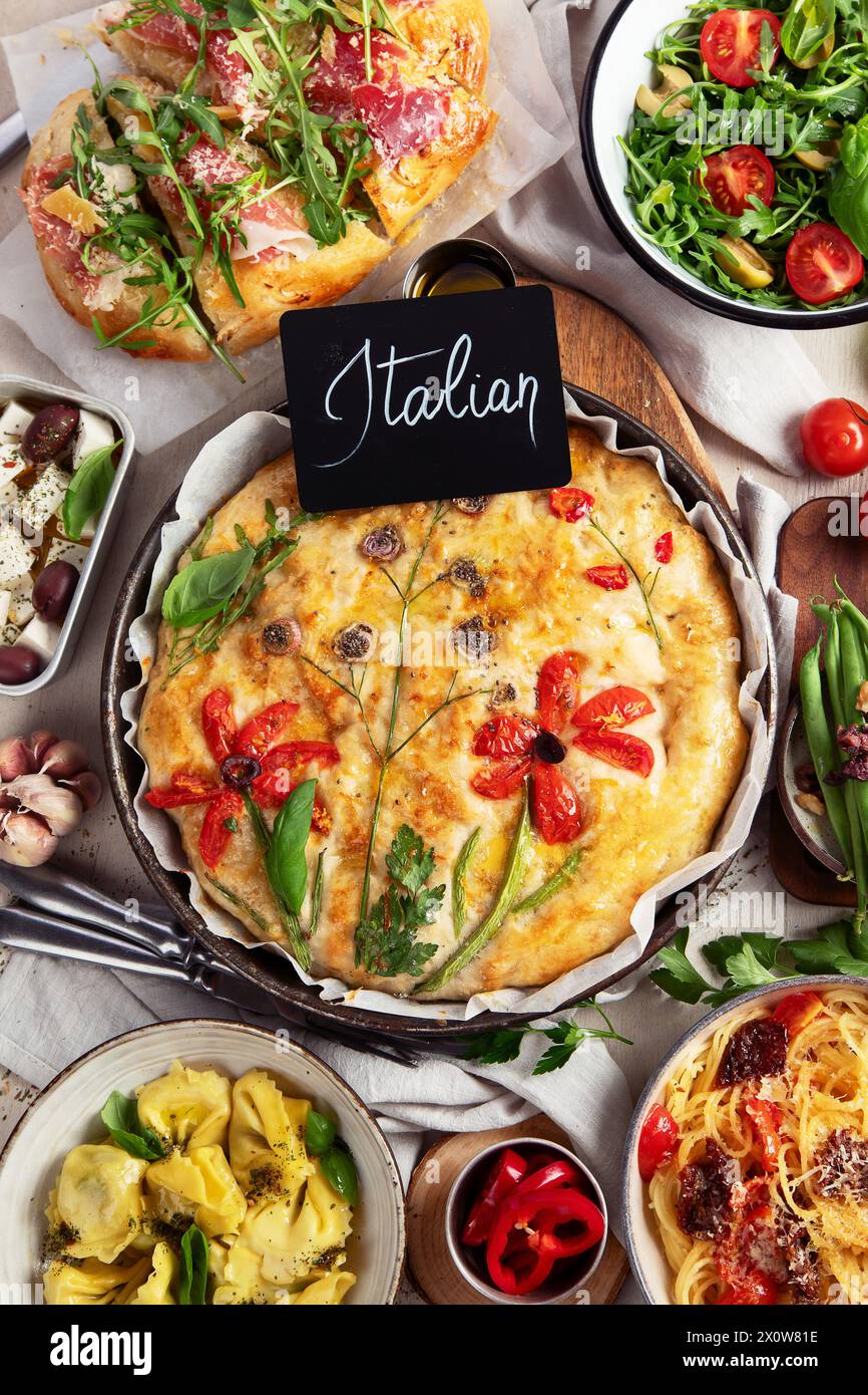 Table of italian meals dishes. Pizza, pasta, ravioli, focaccia on white ...