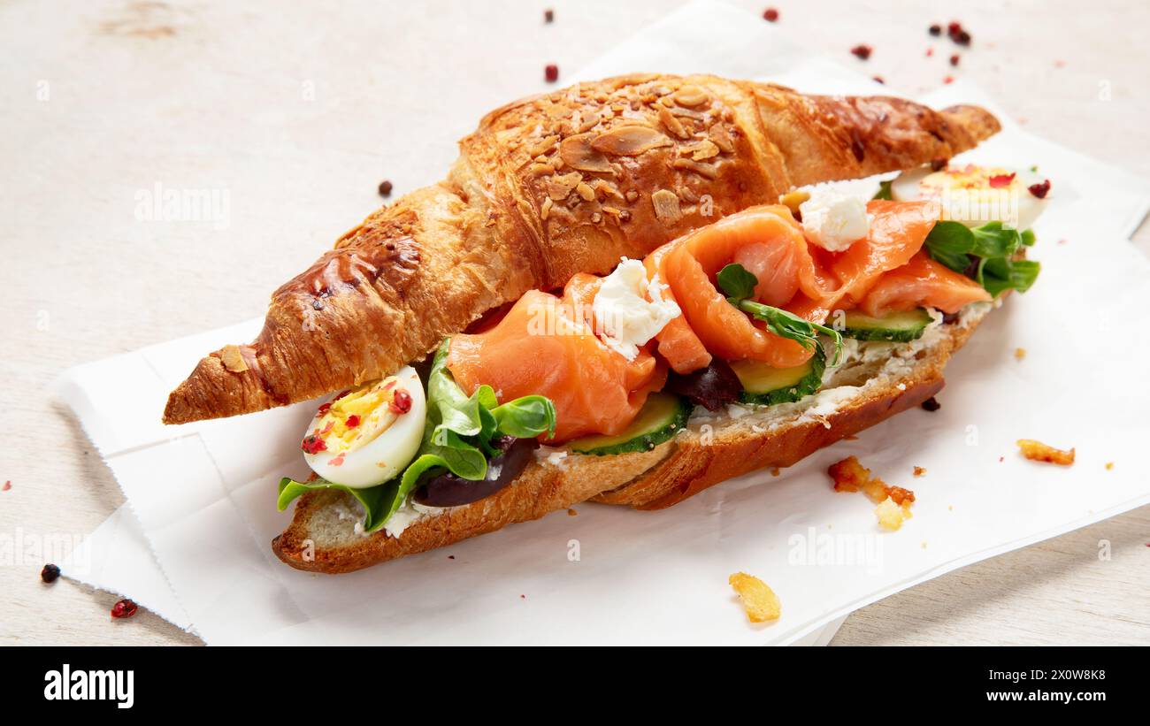 Salted healthy breakfast on light background. Fresh salmon croissant ...