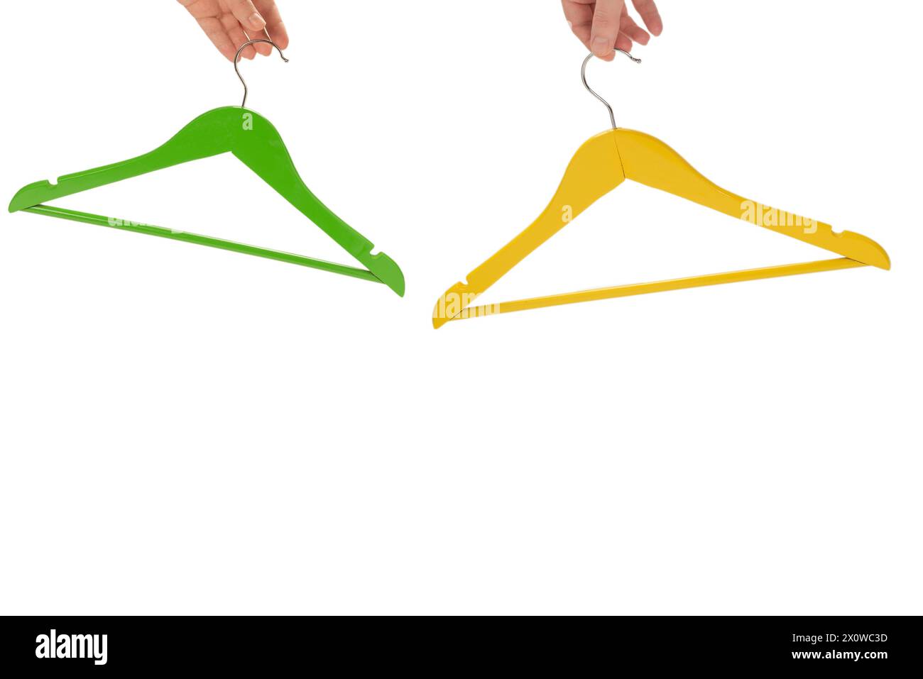 Yellow hanger in woman hand isolated on white background Stock Photo ...