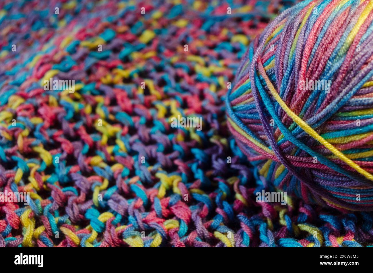 Ball of multi coloured wool on a crotched blanket with depth of field ...