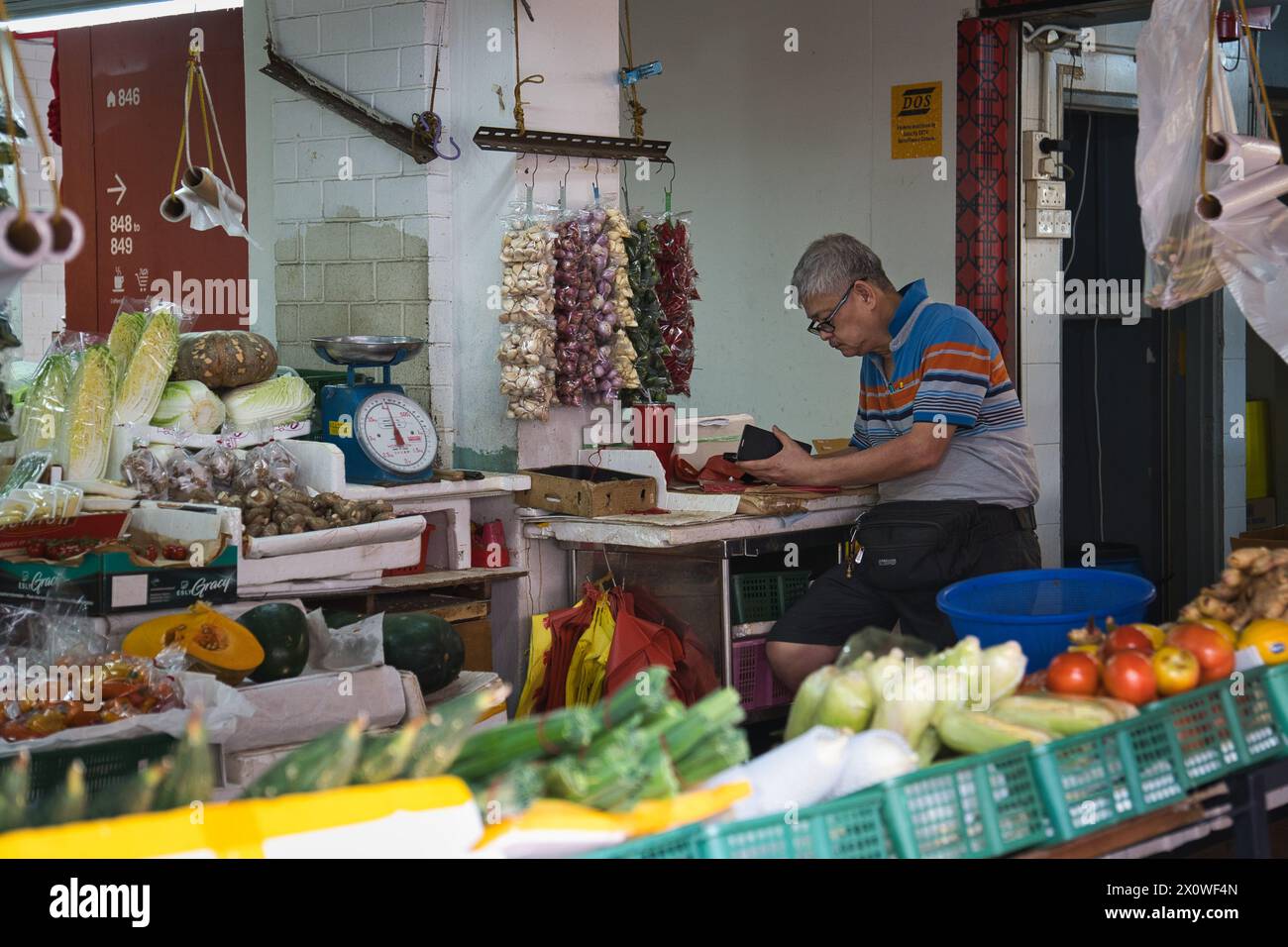 Singapore - September 28, 2022: Elderly store keeper at a market fresh ...