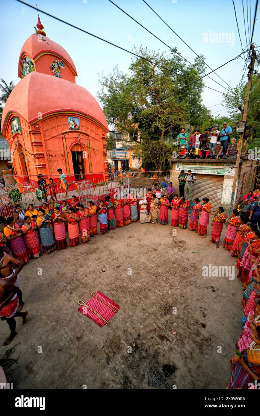 Bagnan, India. 13th Apr, 2024. Devotees seen stand in queue to perform ...
