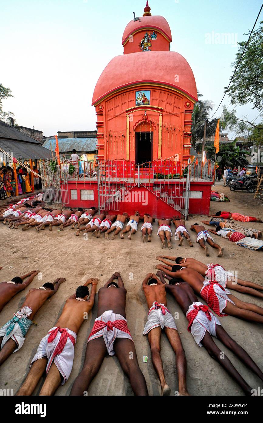 Bagnan, India. 13th Apr, 2024. Devotees seen laid on the ground to ...