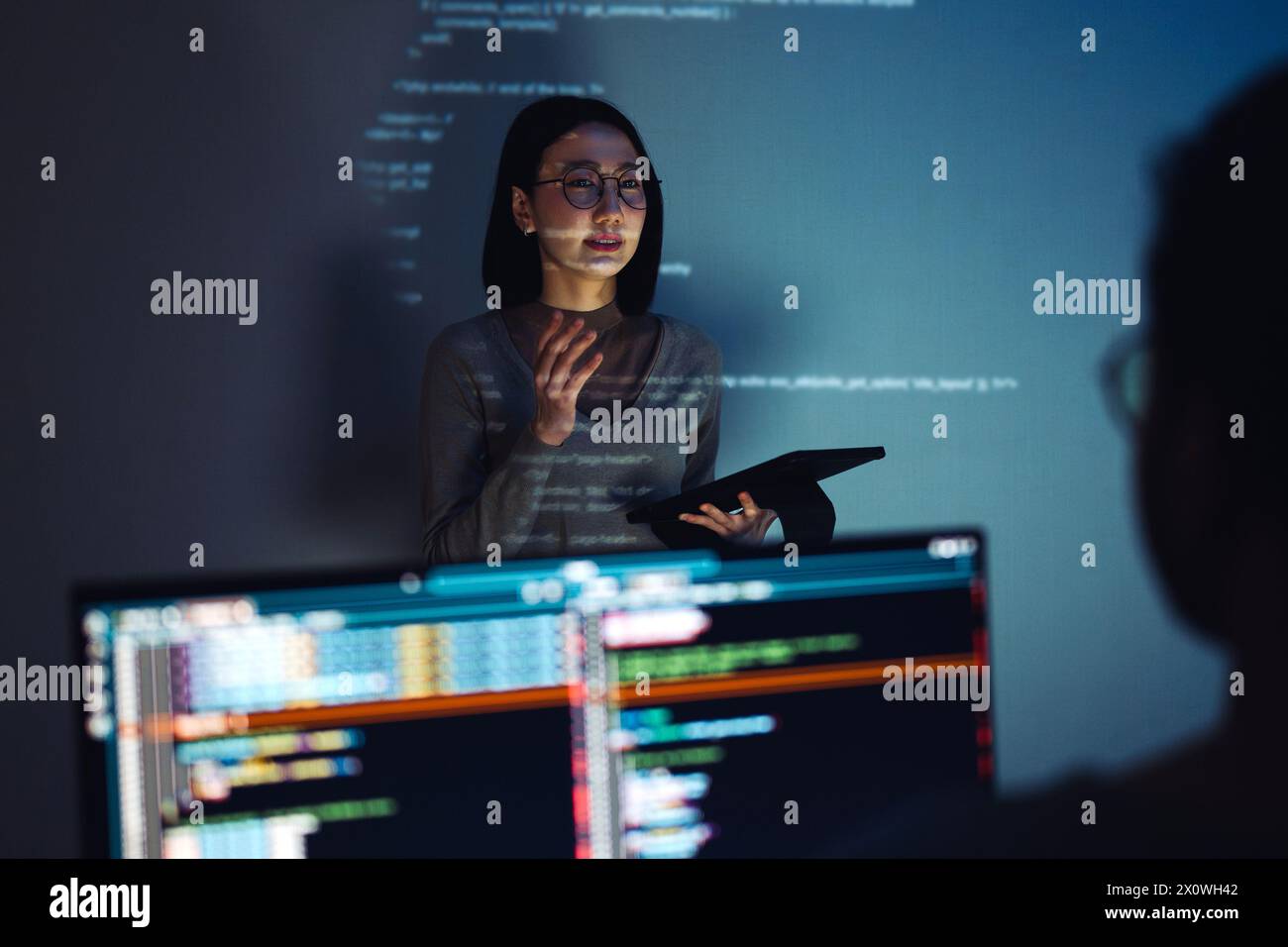 Asian Woman Developer Presentation About Coding Software Data With Devops Team At Night In