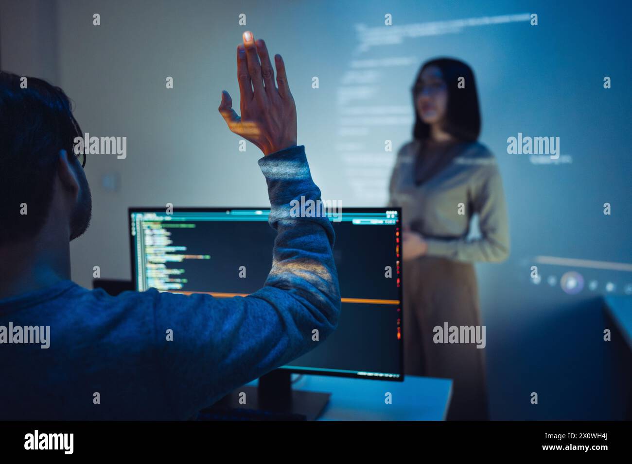 trainee developer hand up to ask speaker about software coding project ...