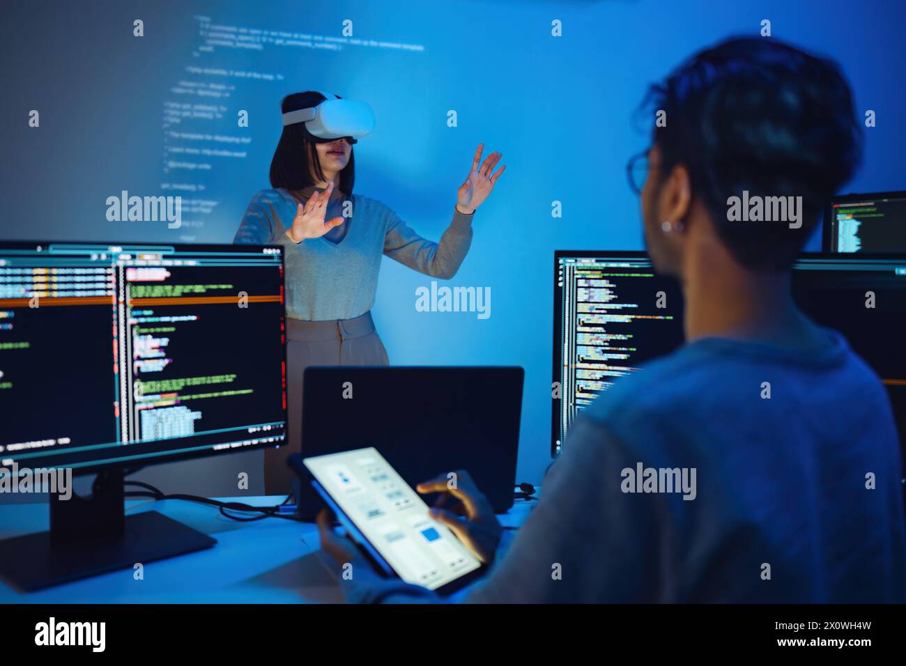 Asian And Indian Developer Devops Team Testing Virtual Reality Coding And Presentation With Ai