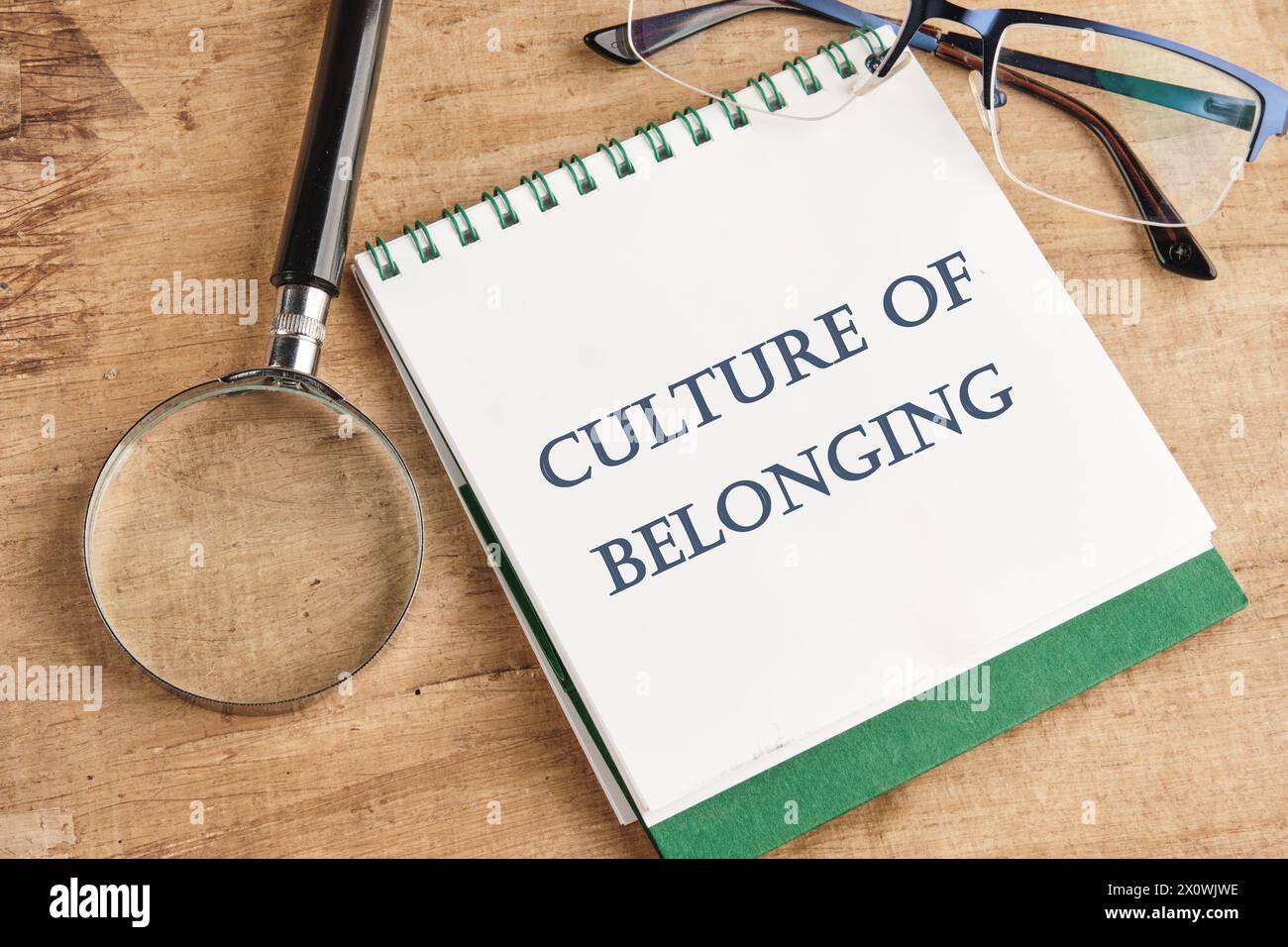 Culture of belonging symbol on a notebook with a magnifying glass and ...