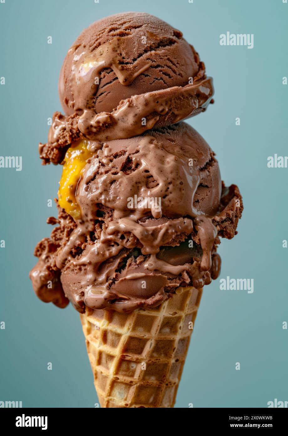 Two scoops of Chocolate ice cream on top ice cream cone blue background ...