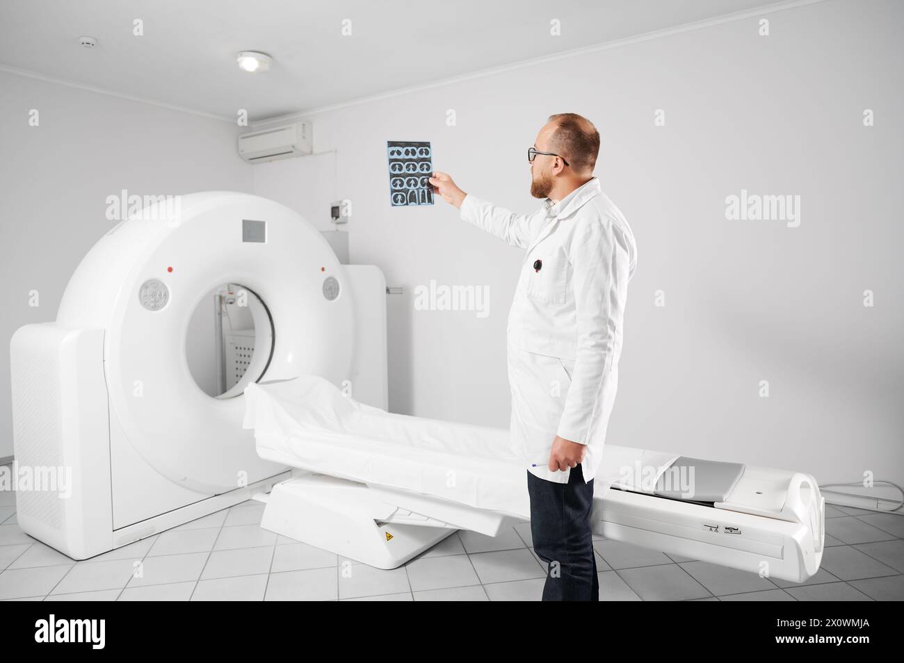 Doctor with medical computed tomography or MRI scanner. Radiologist ...