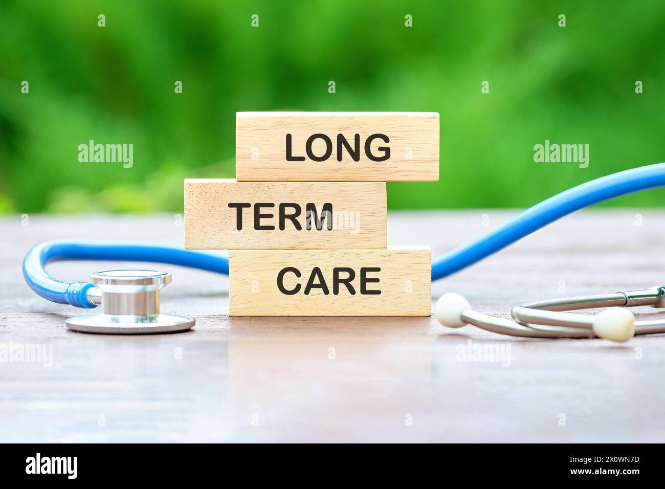 Medical concept. LONG TERM CARE text on wooden blocks on a green ...