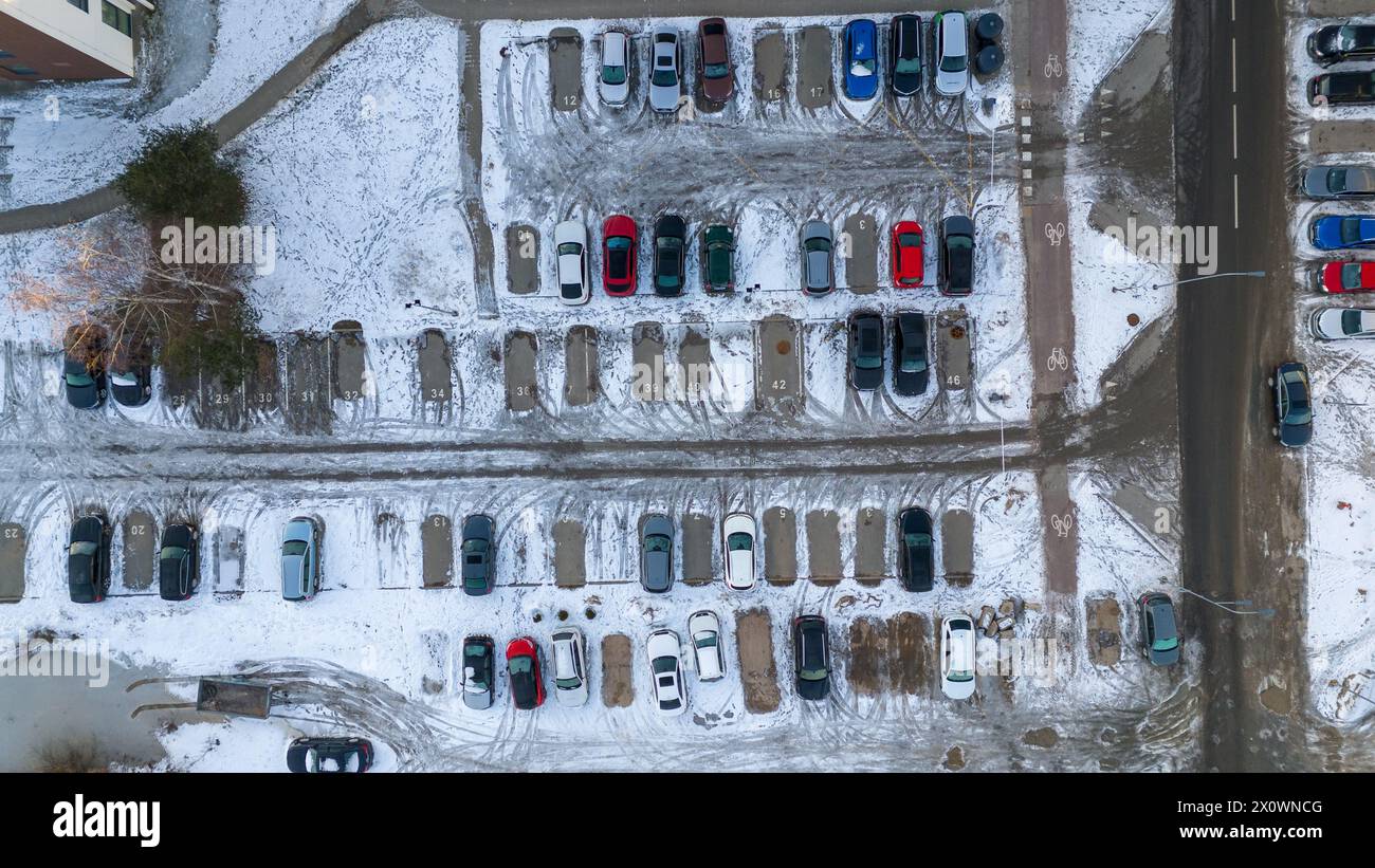 Drone photography of parking lot covered by snow near an apartment ...
