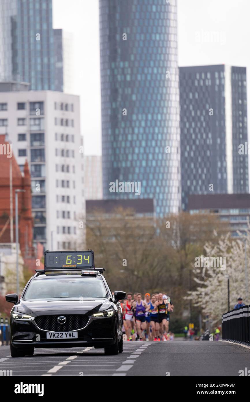 Manchester, UK. 14th April 2024. Elite runners with pace car ...