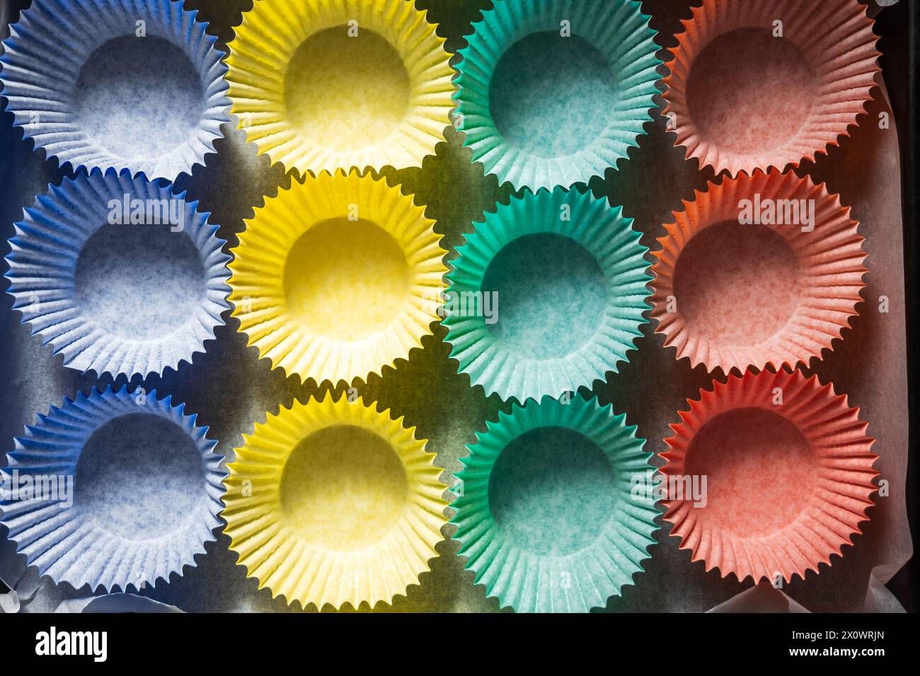 A vibrant display of baking cups in shades of green, light blue, and ...