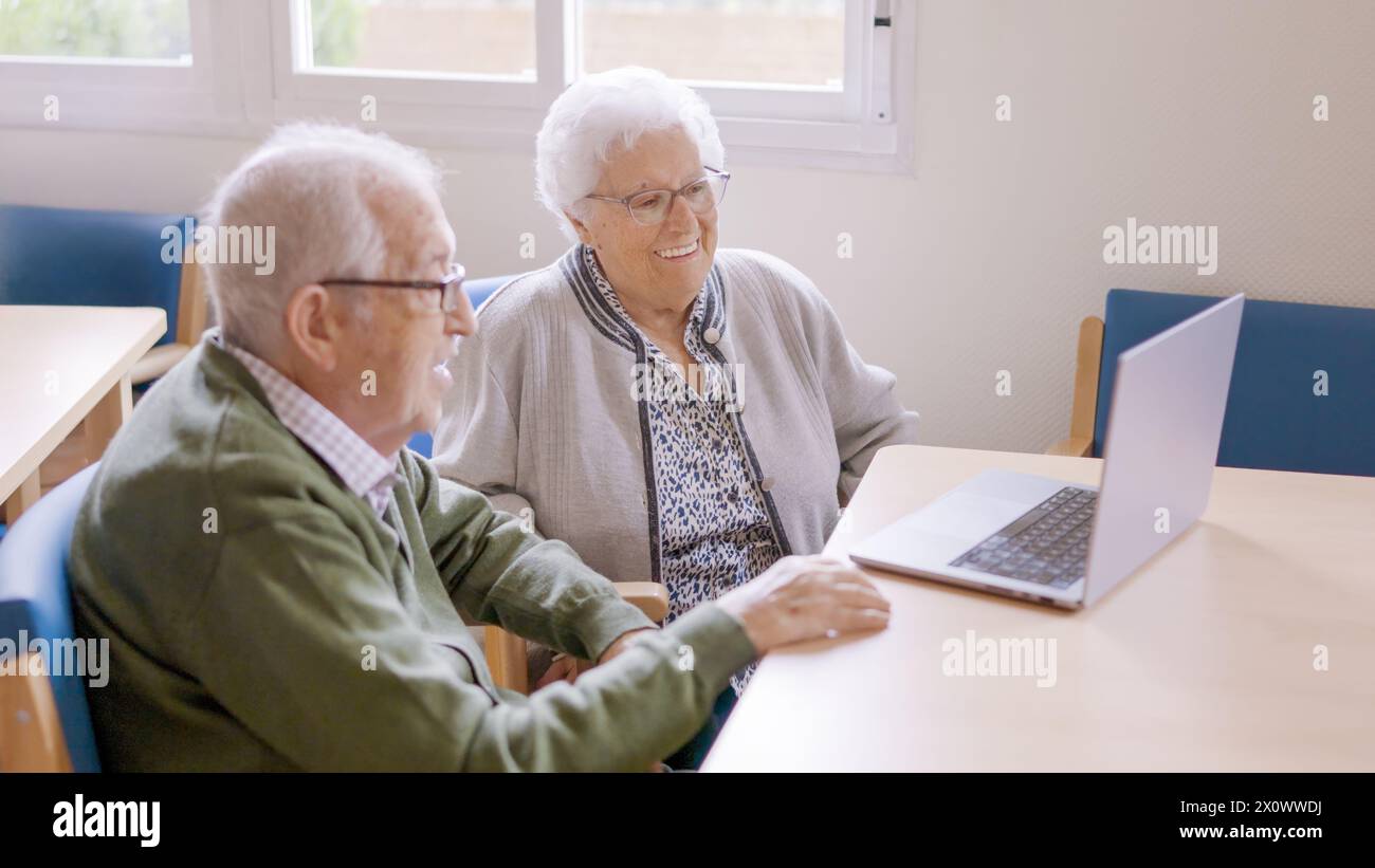 Grandparents smiling during a video call talking to their family Stock ...