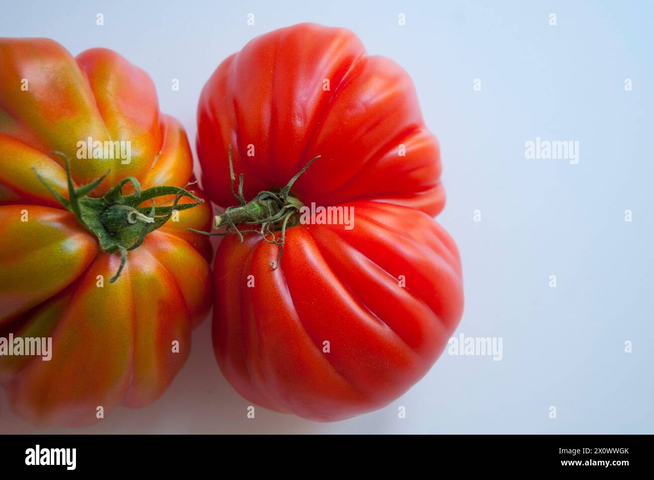 Two raf tomatoes in contact. Close view Stock Photo - Alamy
