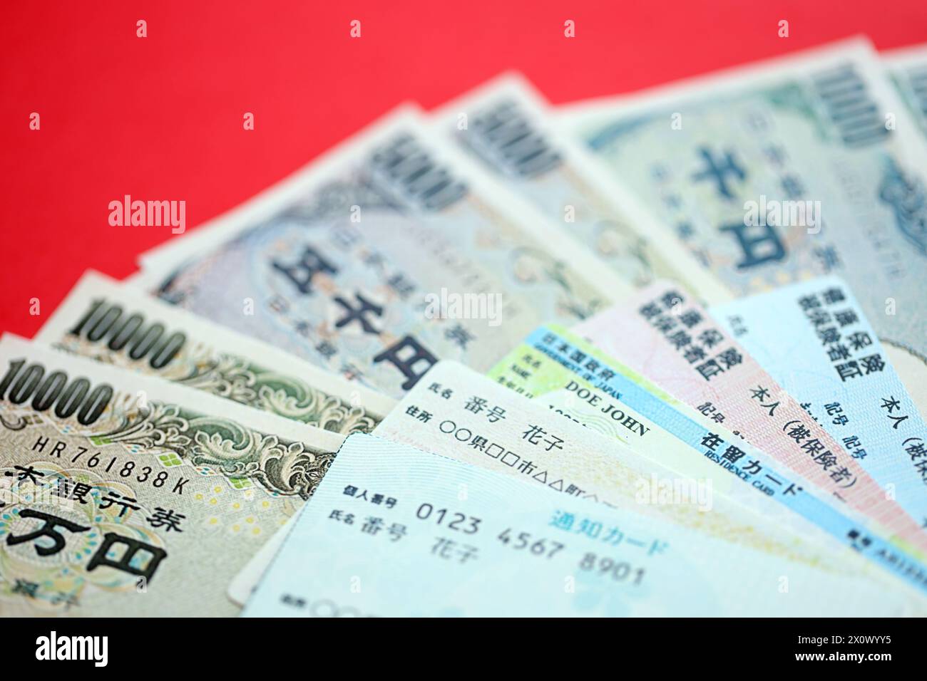 Light blue and red Japan Health Insurance cards on table with japanese ...