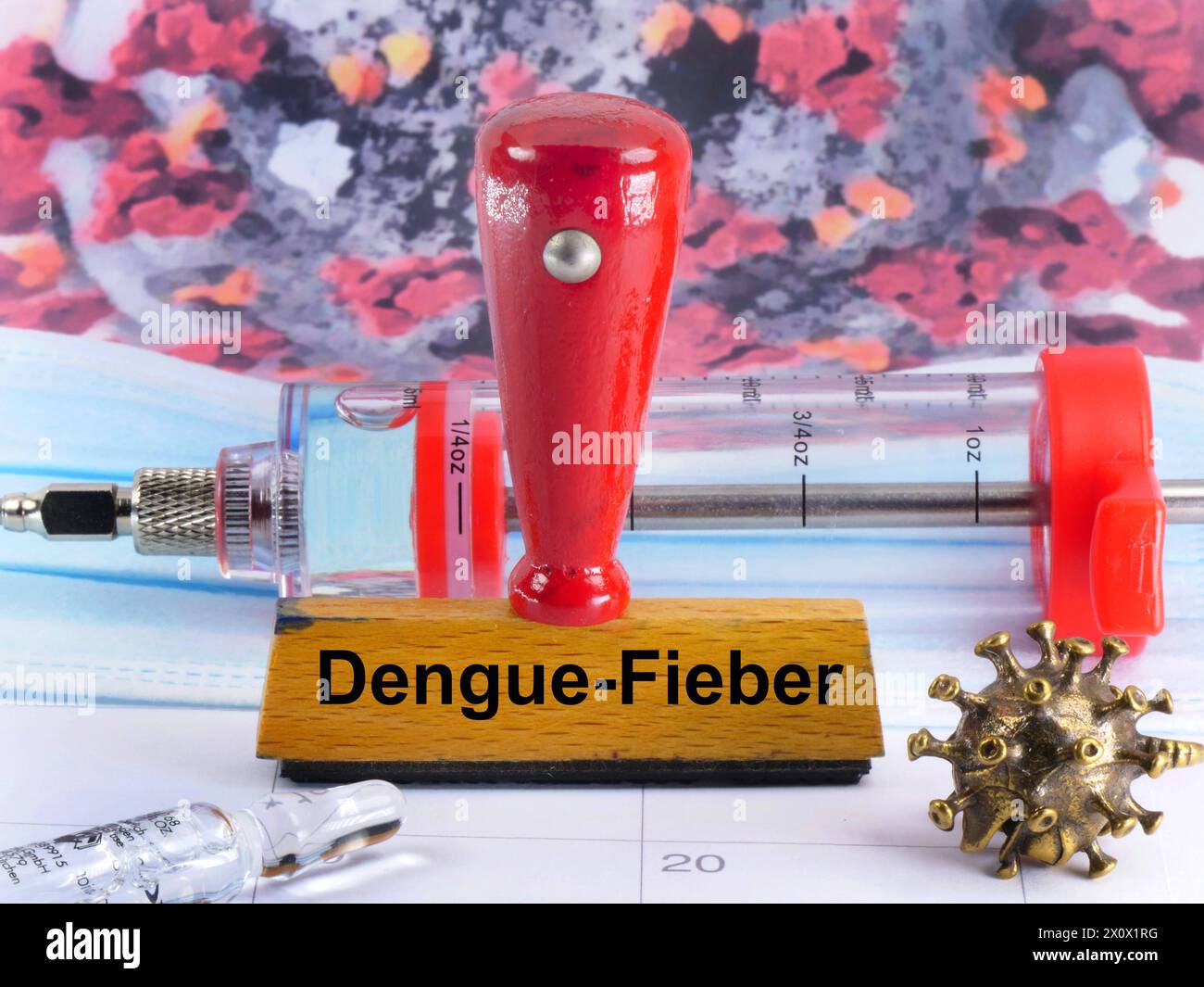 Symbolbild Dengue-Fieber als Aufdruck auf einem roten Stempel ...