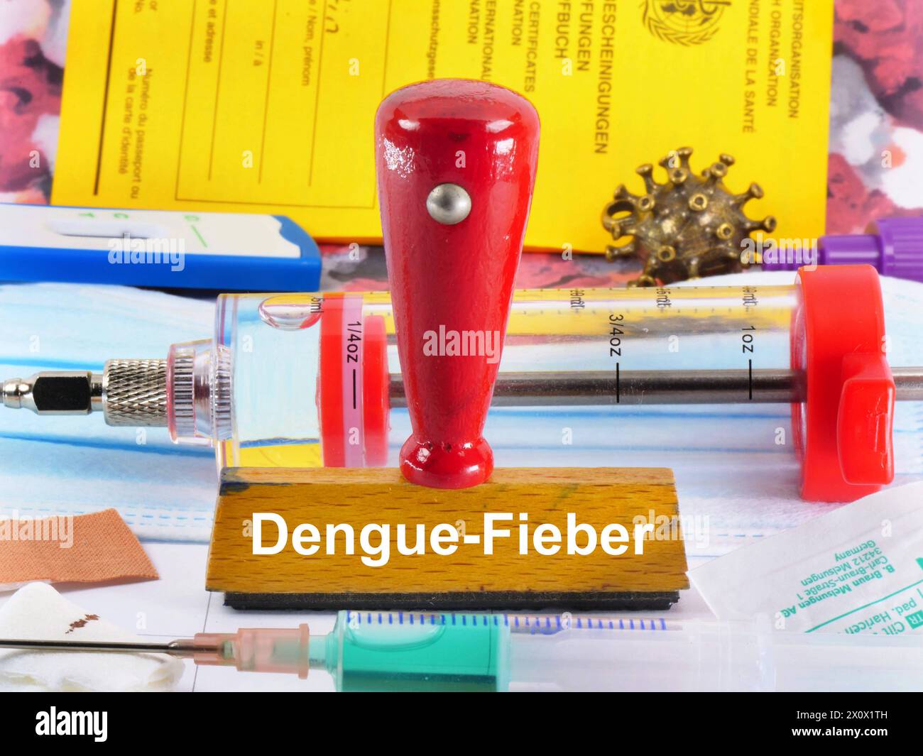 Symbolbild Dengue-Fieber als Aufdruck auf einem roten Stempel ...