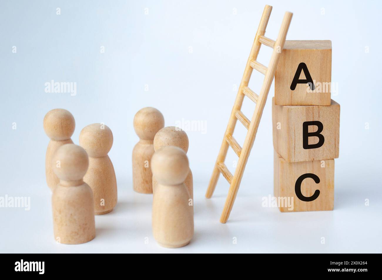 ABC text on wooden cubes with ladder and doll figures on white ...