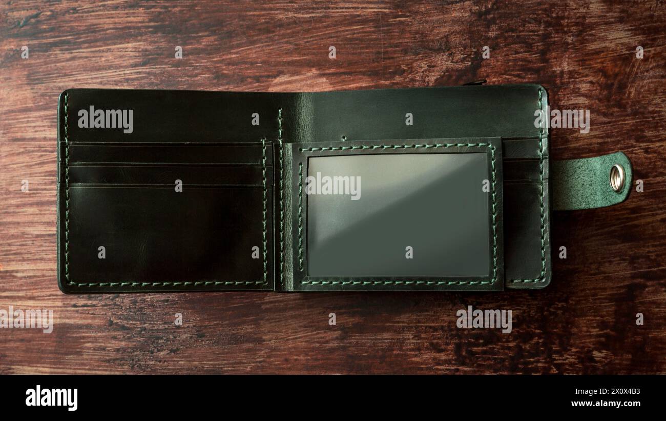 Men's wallet made black leather on dark stylish wood. Shooting for the ...