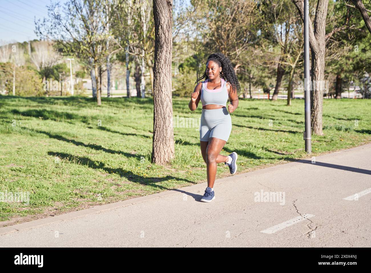 young curvy woman training. african american woman running Stock Photo ...