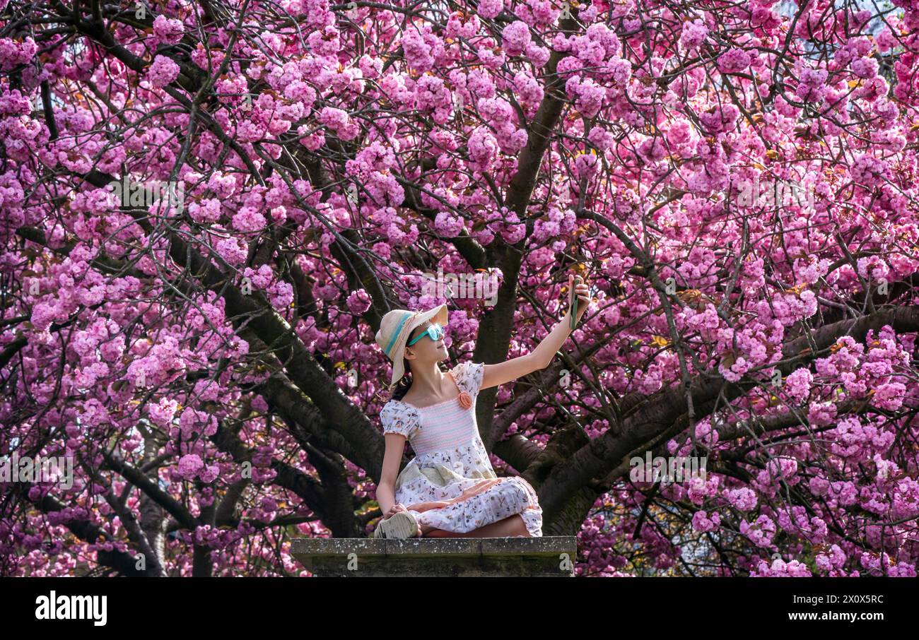 Photograph posed by model. Maja Lawson takes a photograph as she enjoys ...