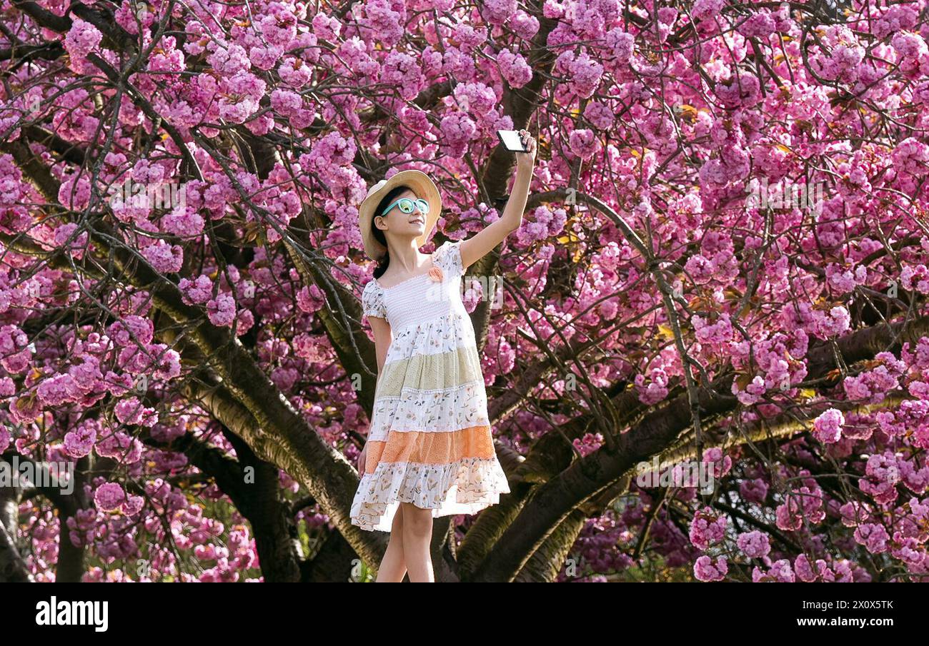 Photograph posed by model. Maja Lawson takes a photograph as she enjoys ...