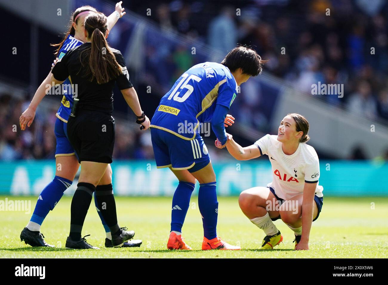 Tottenham Hotspur's Grace Clinton (right) is helped to their feet by ...