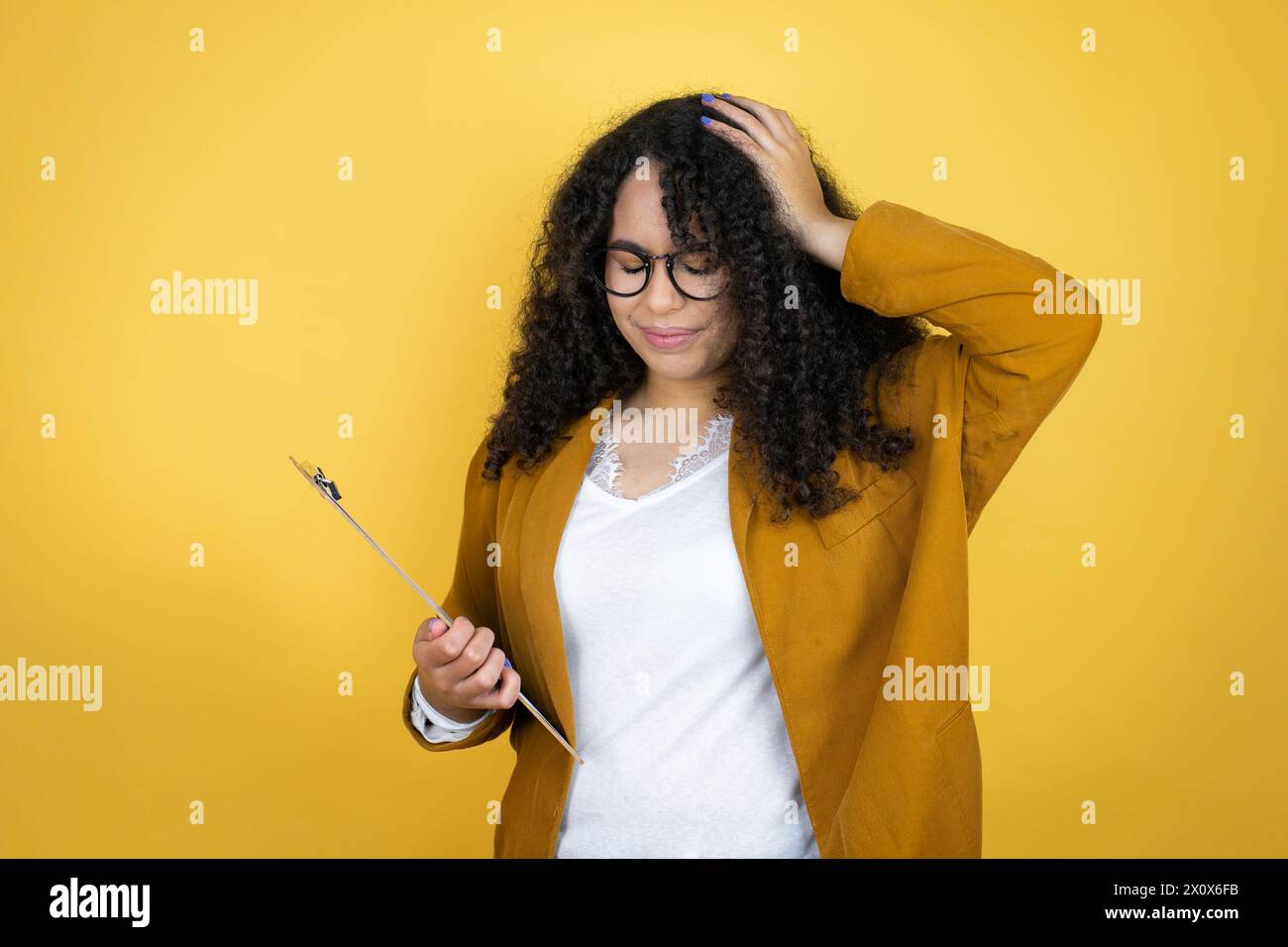 African american business woman with paperwork in hands over yellow ...