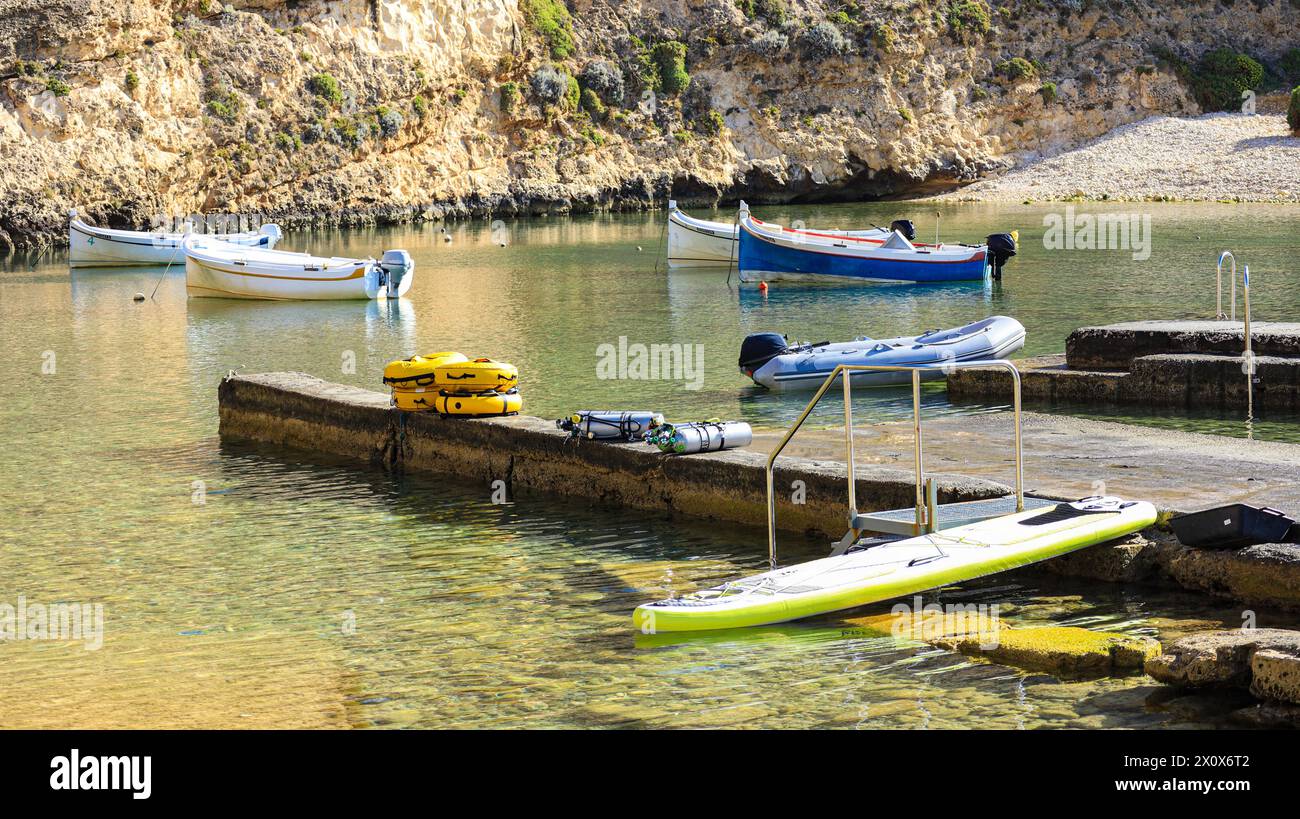 Boats and watersport equipment at the Inland Sea, Gozo Stock Photo - Alamy
