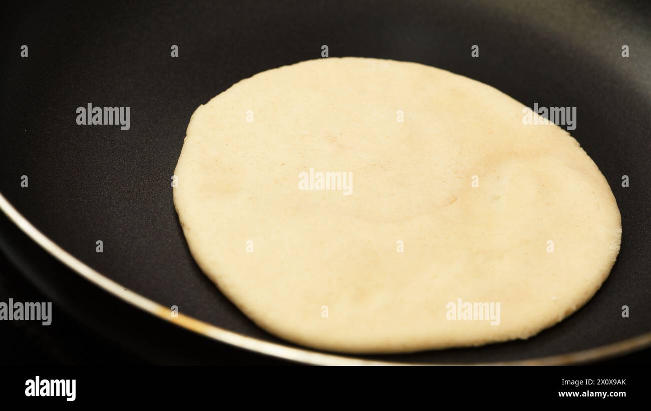 Making sourdough leavened pita-like flatbread on dry frying pan Stock ...